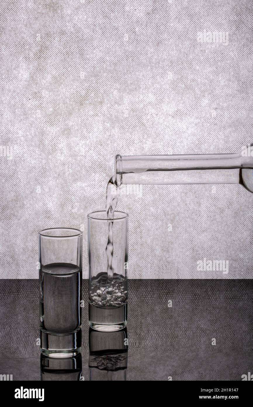 Still life with pouring liquid into a glass Stock Photo - Alamy