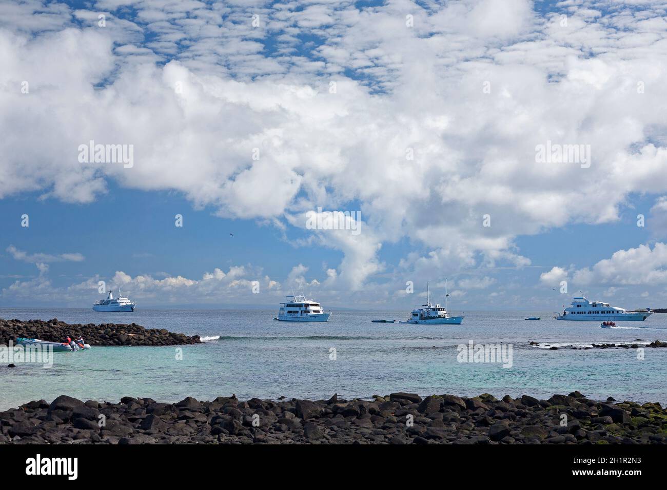 Cruise boats anchored in Pacific Ocean at Punta Suarez, Espanola Island ...