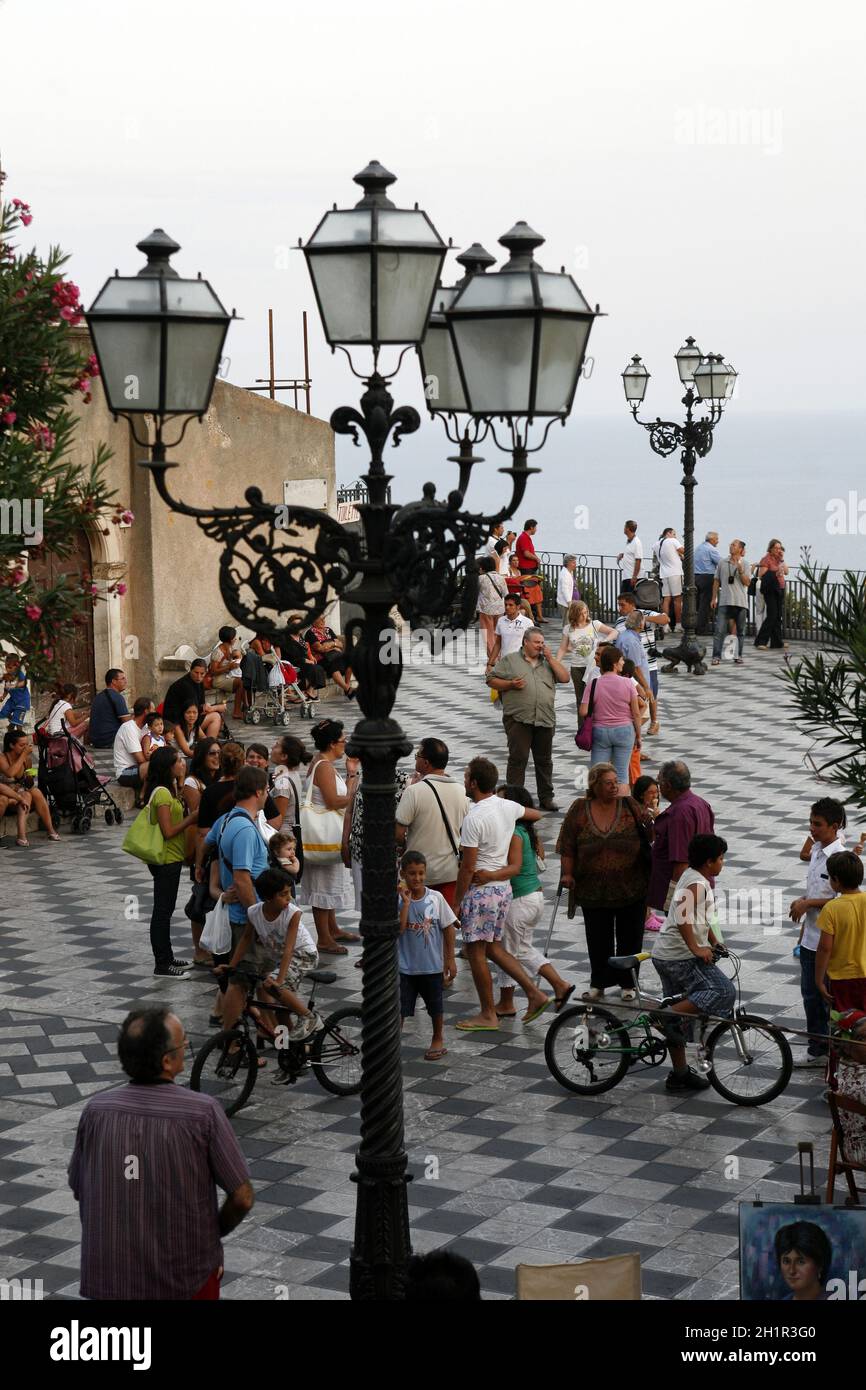 tourists at sunset on the view point at Belvedere di Taormina in the ...
