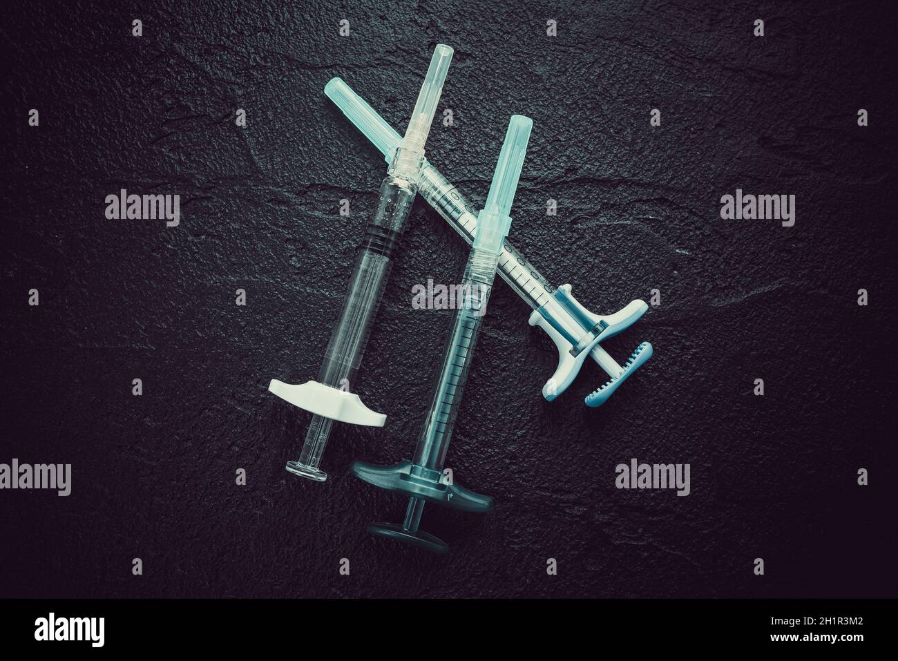 Medical injection syringes with solution on black background Stock ...