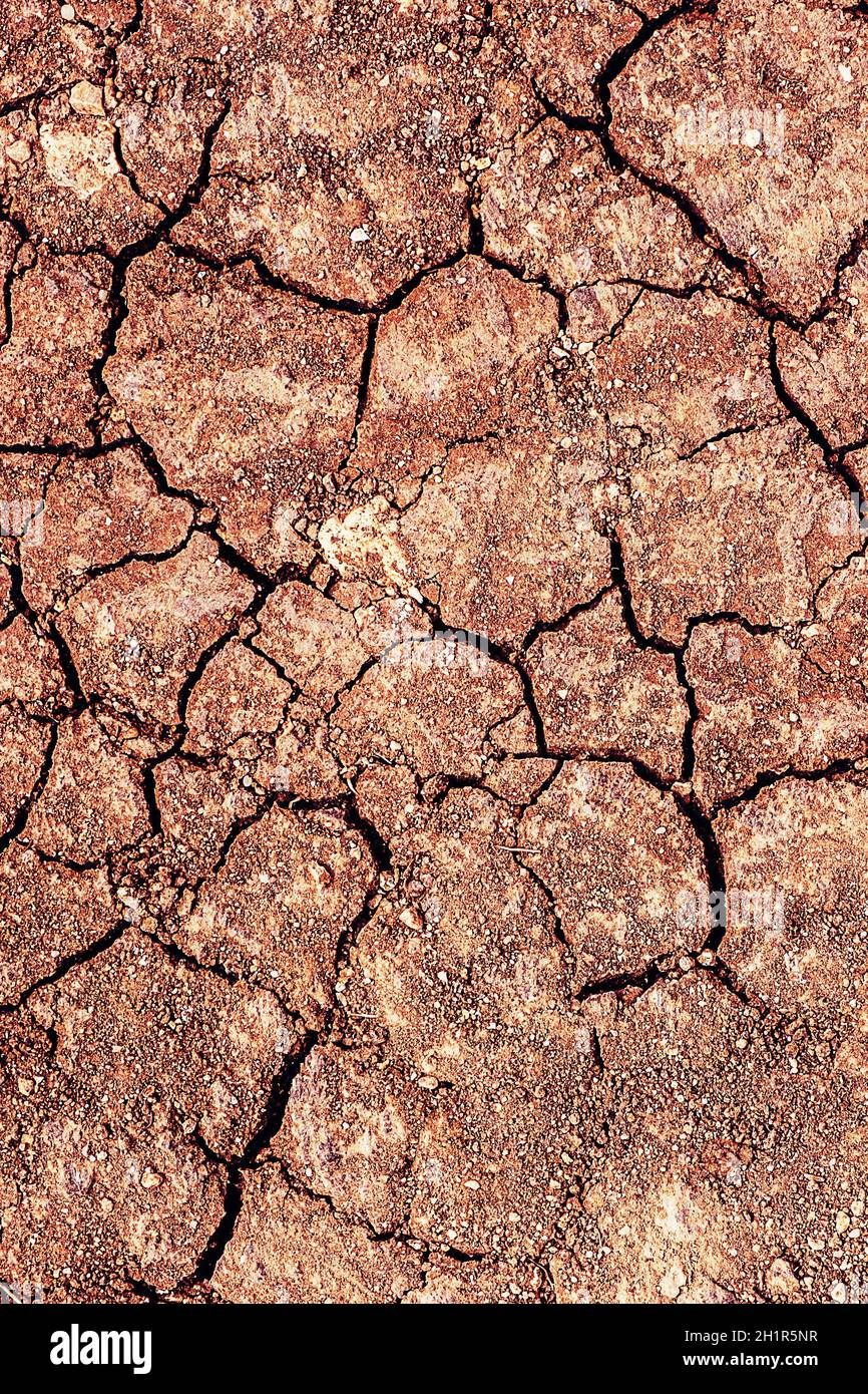 Red dry cracked ground. Dried clay texture and patterns cracked surface ...