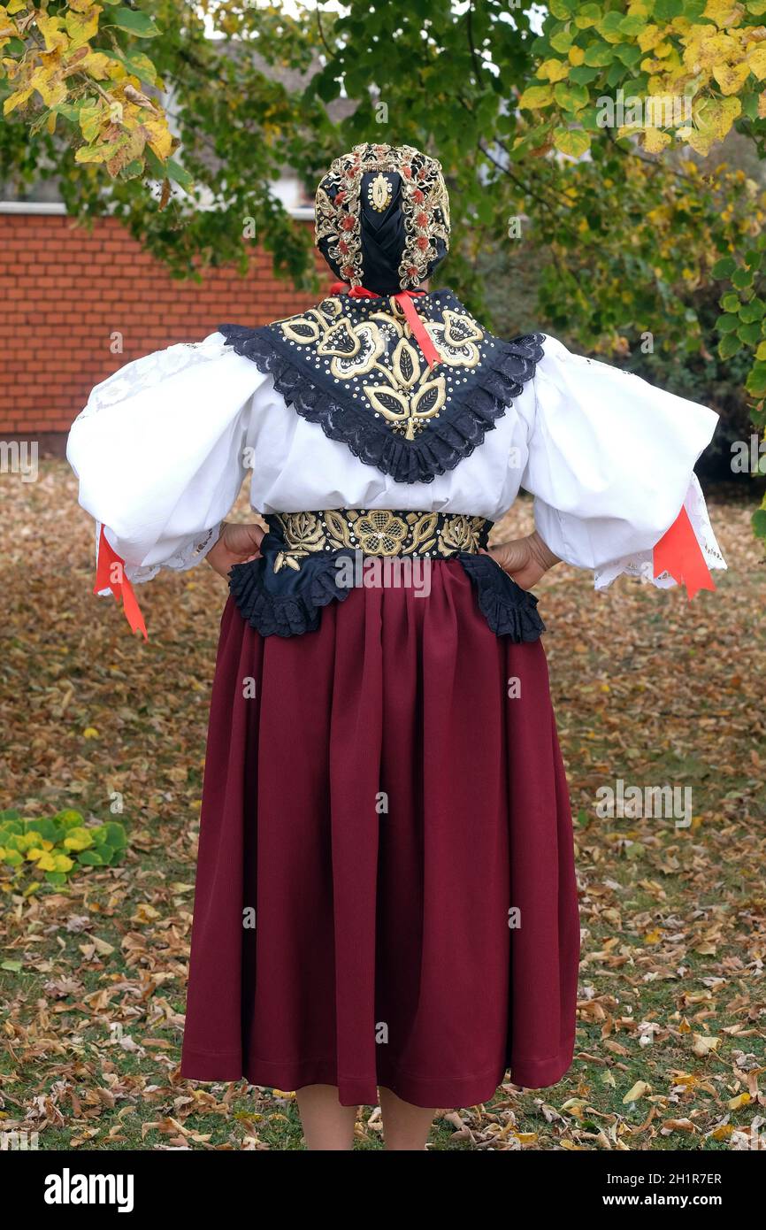 Woman dressed in folk costumes go to the church at the Mass on ...