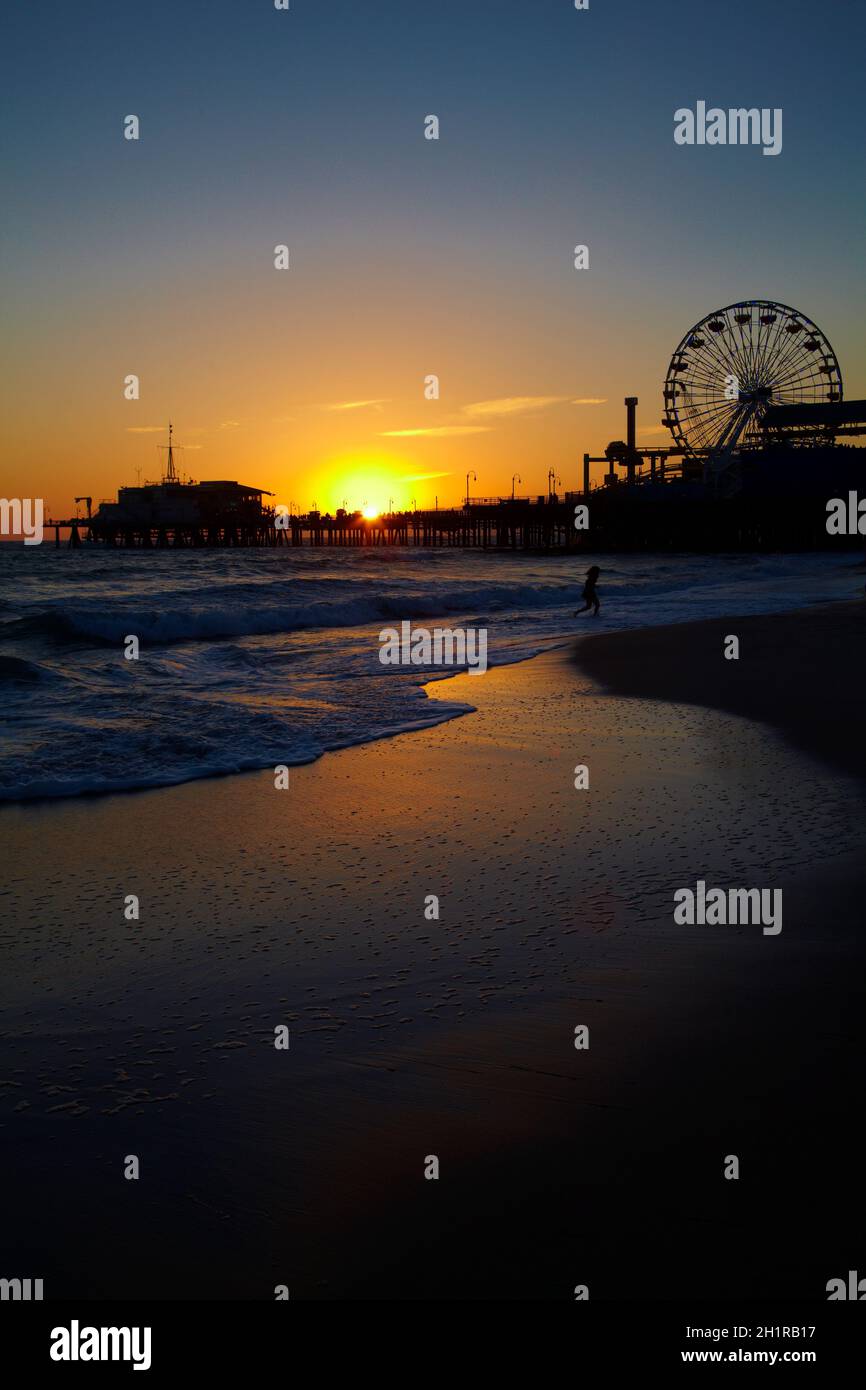 Beach, Ferris wheel and roller coaster at sunset, Pacific Park, Santa ...