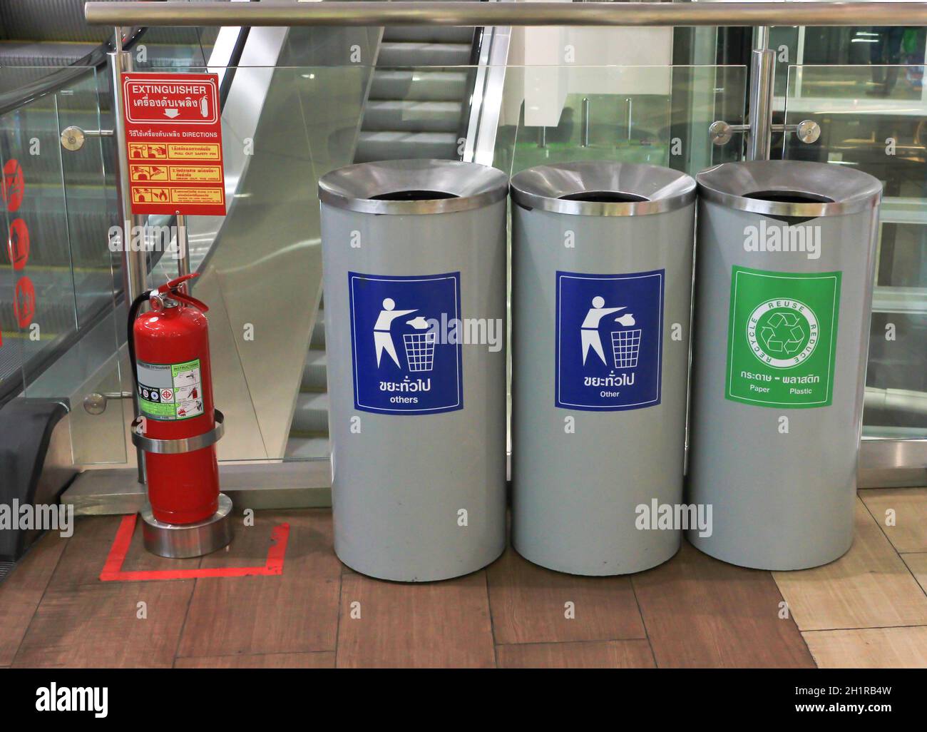 Three bins recycling symbol in shopping mall Stock Photo - Alamy