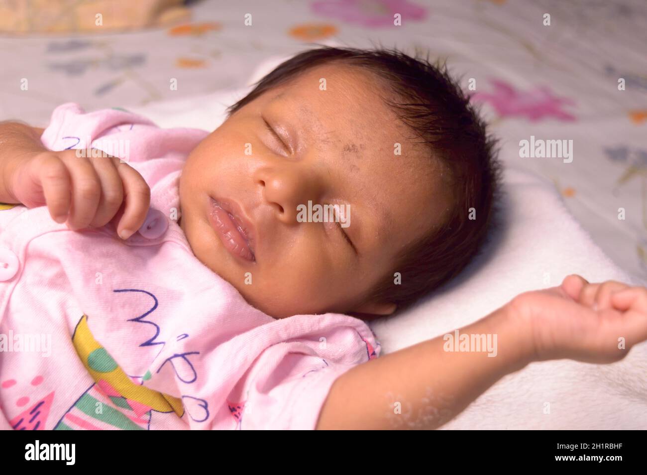 Close up face of a cute sleeping newborn baby. Closeup portrait of a ...