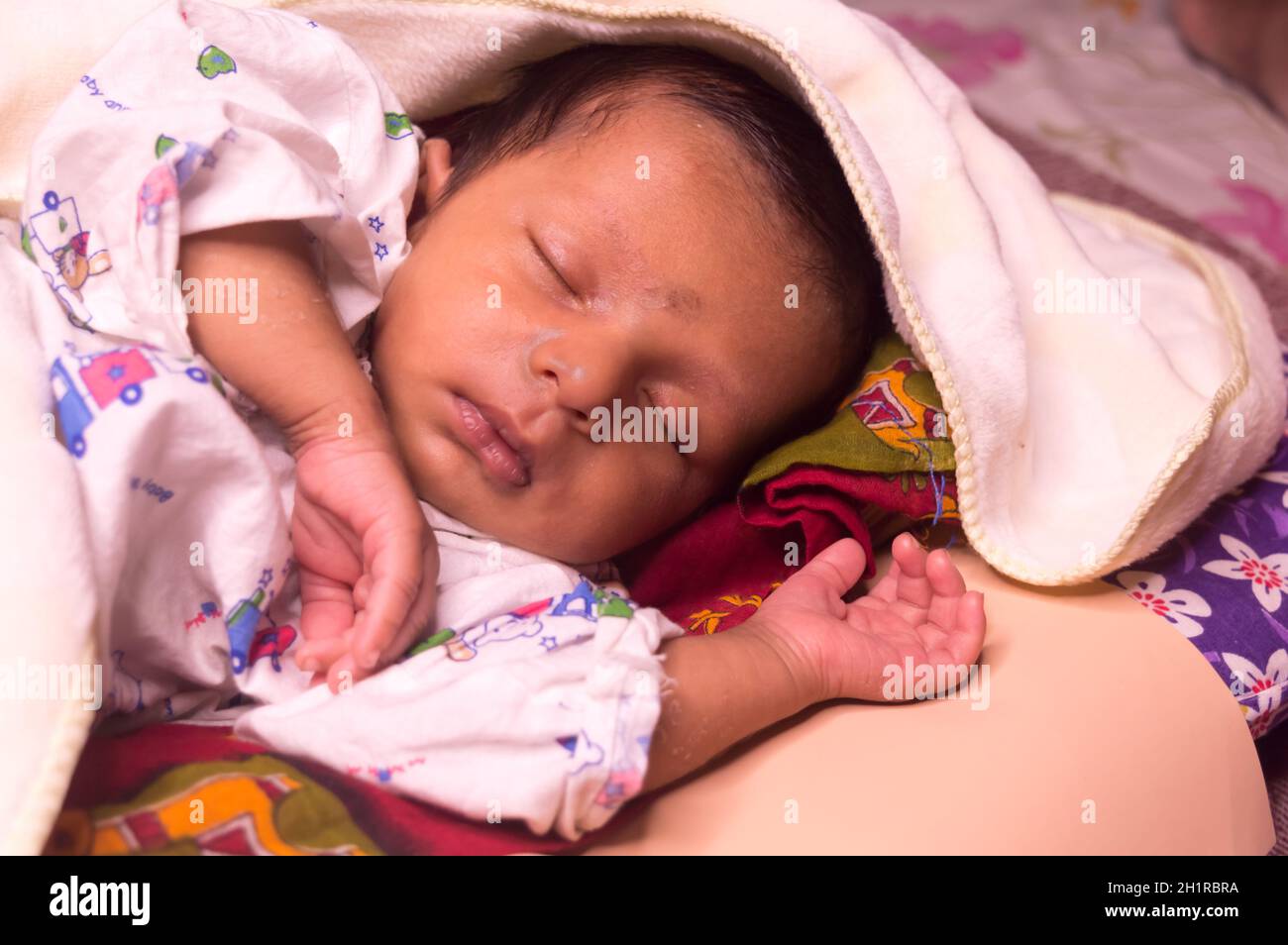 Close up face of cute sleeping newborn baby boy in drowsy eyes with ...
