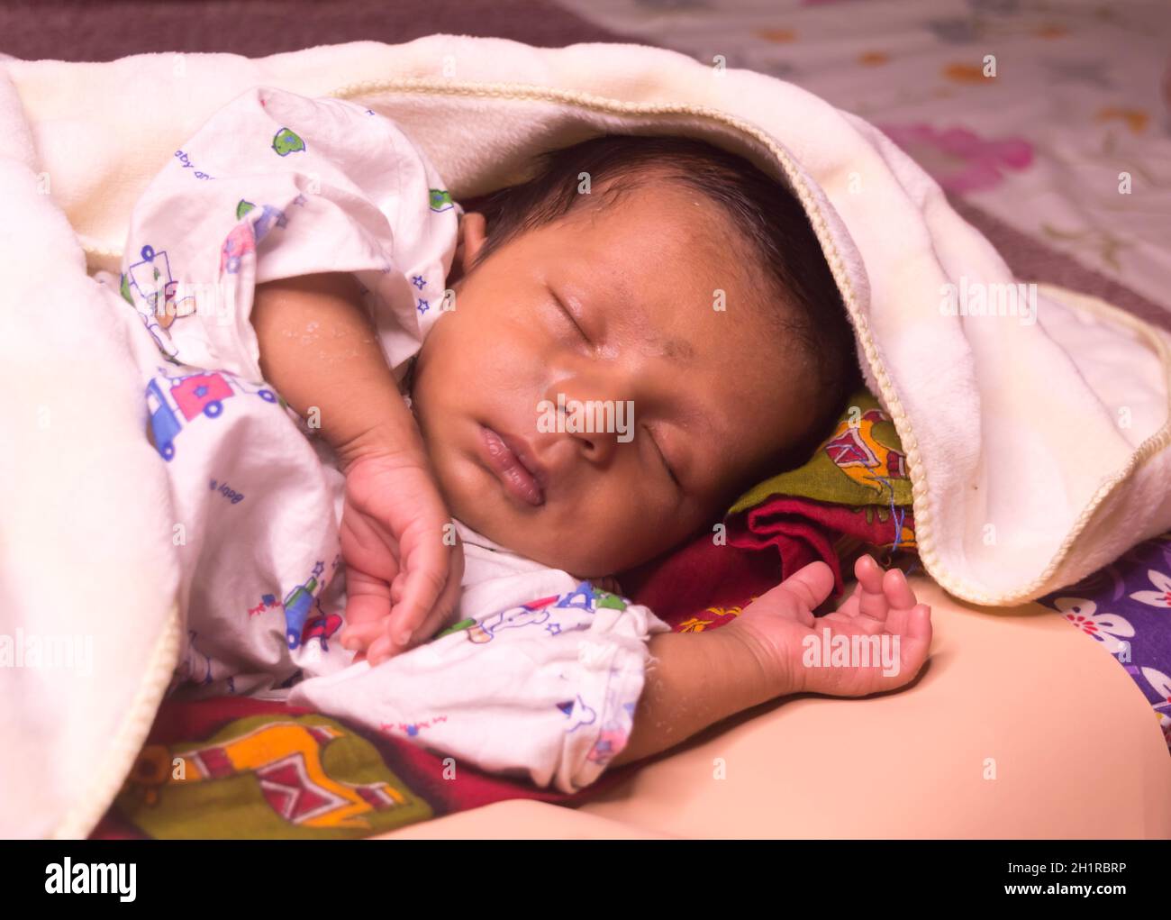 Close up face of cute sleeping newborn baby boy in drowsy eyes with ...