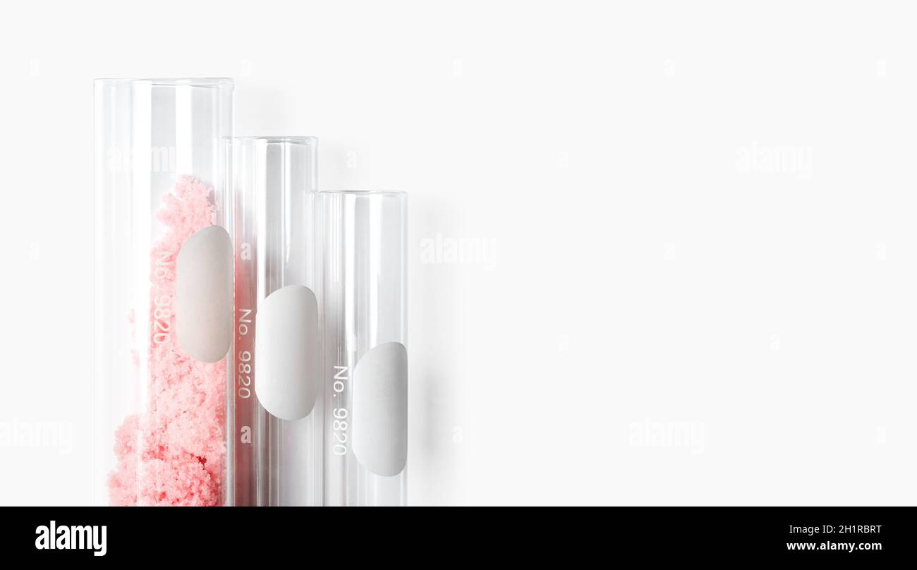 Pink flake chemical in test tube. Cosmetic chemical ingredient on ...