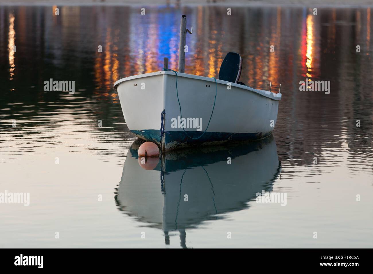 Beautiful Sunset scene with a small boat Stock Photo - Alamy