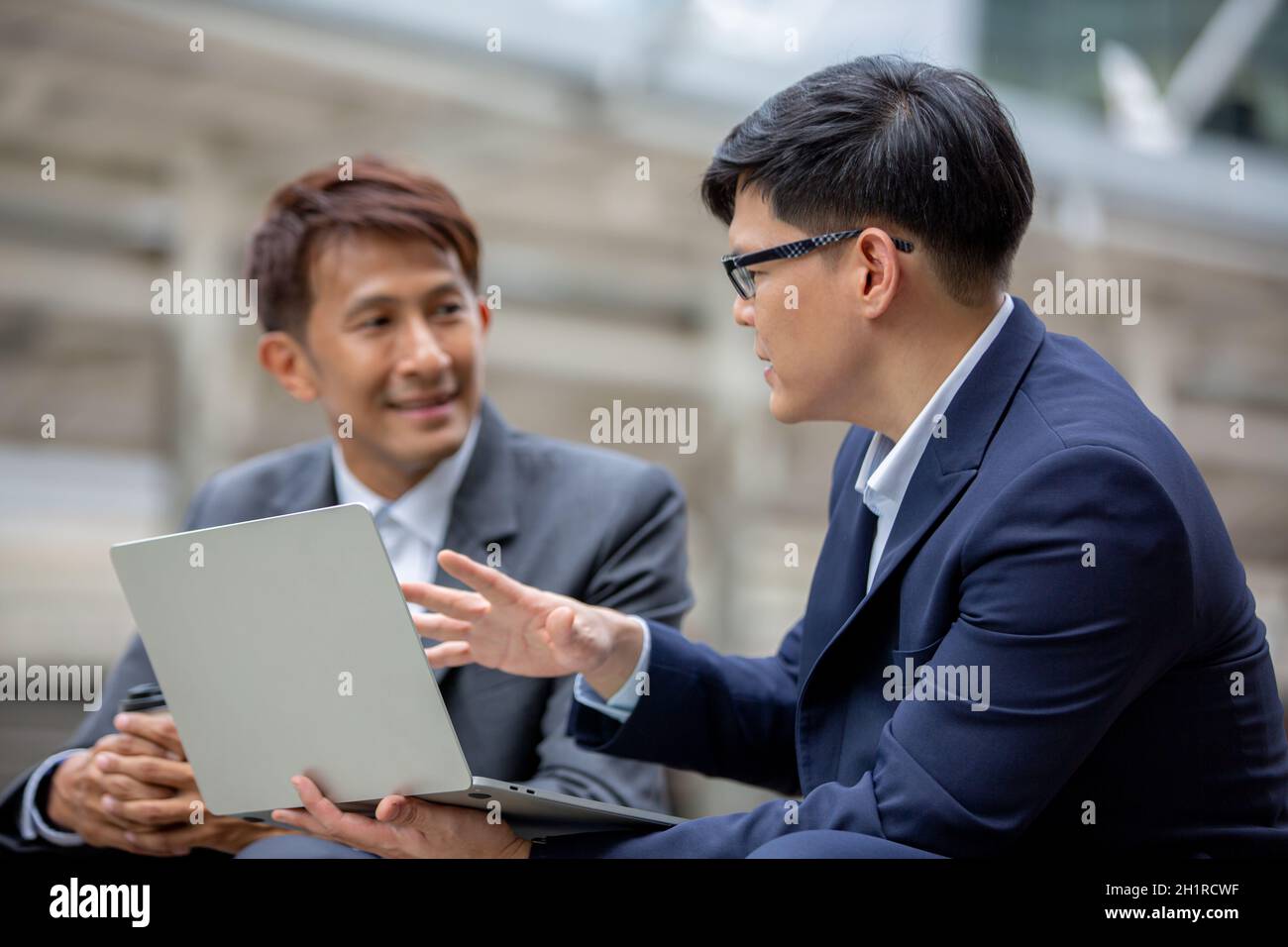 business people using laptop at outside of office Stock Photo - Alamy