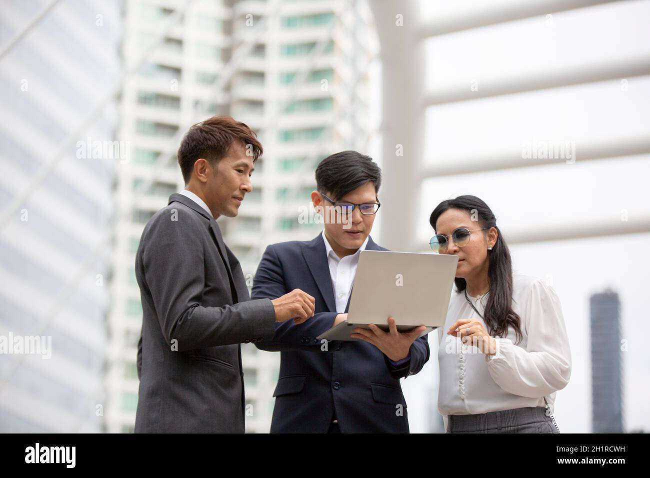 business people using laptop at outside of office Stock Photo - Alamy
