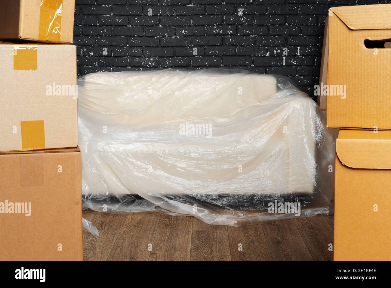 Moving in or moving out concept. Stack of boxes and packed furniture ...