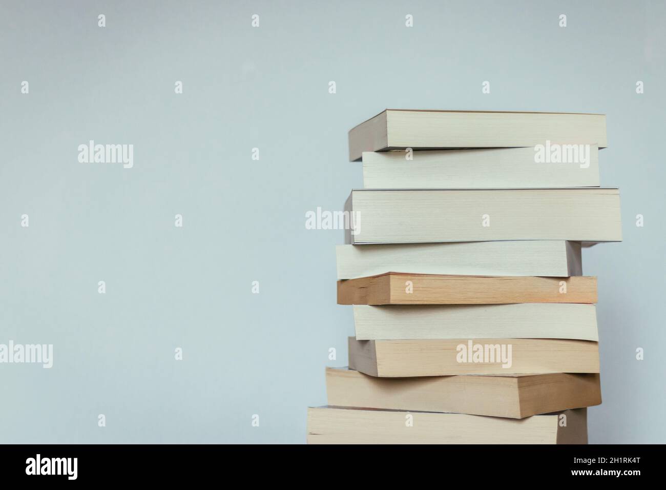 Stack of books before grey background Stock Photo - Alamy