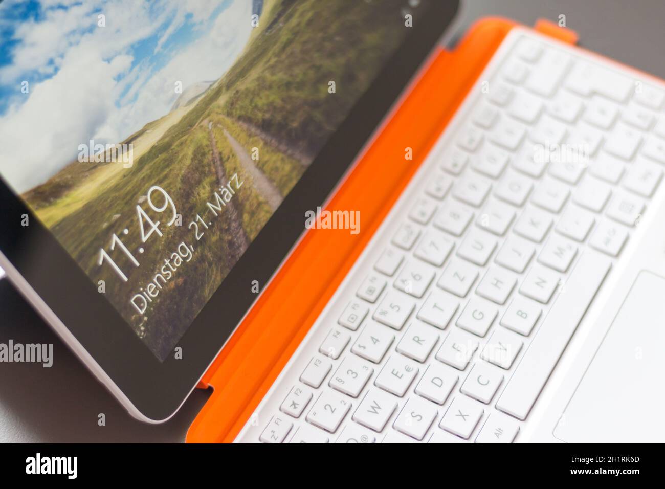 Close-up of white orange convertible laptop and keyboard Stock Photo ...