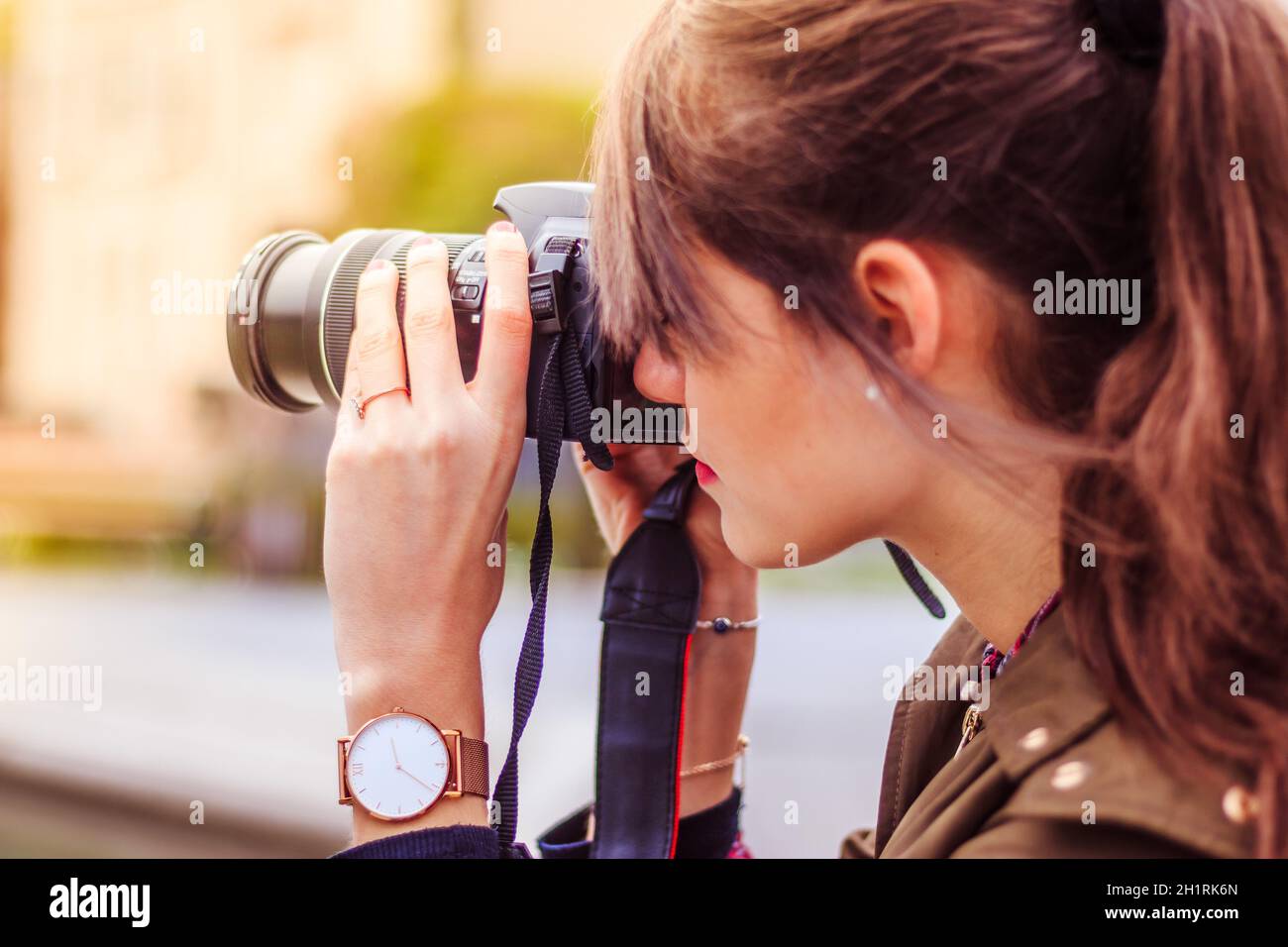 Young beautiful girl is taking a picture with her camera. View from ...