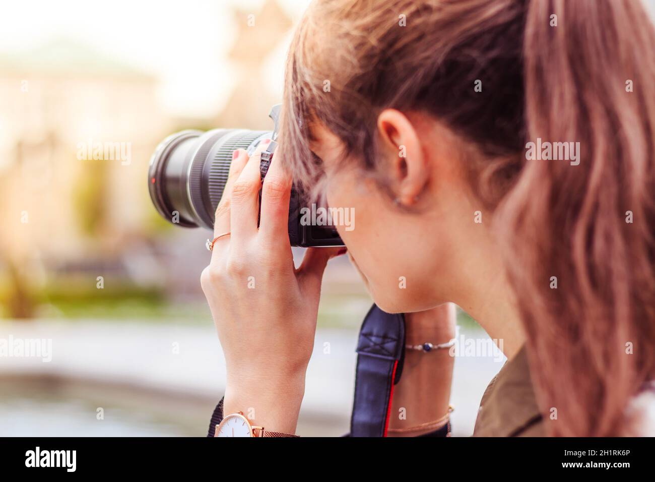 Young beautiful girl is taking a picture with her camera. View from ...