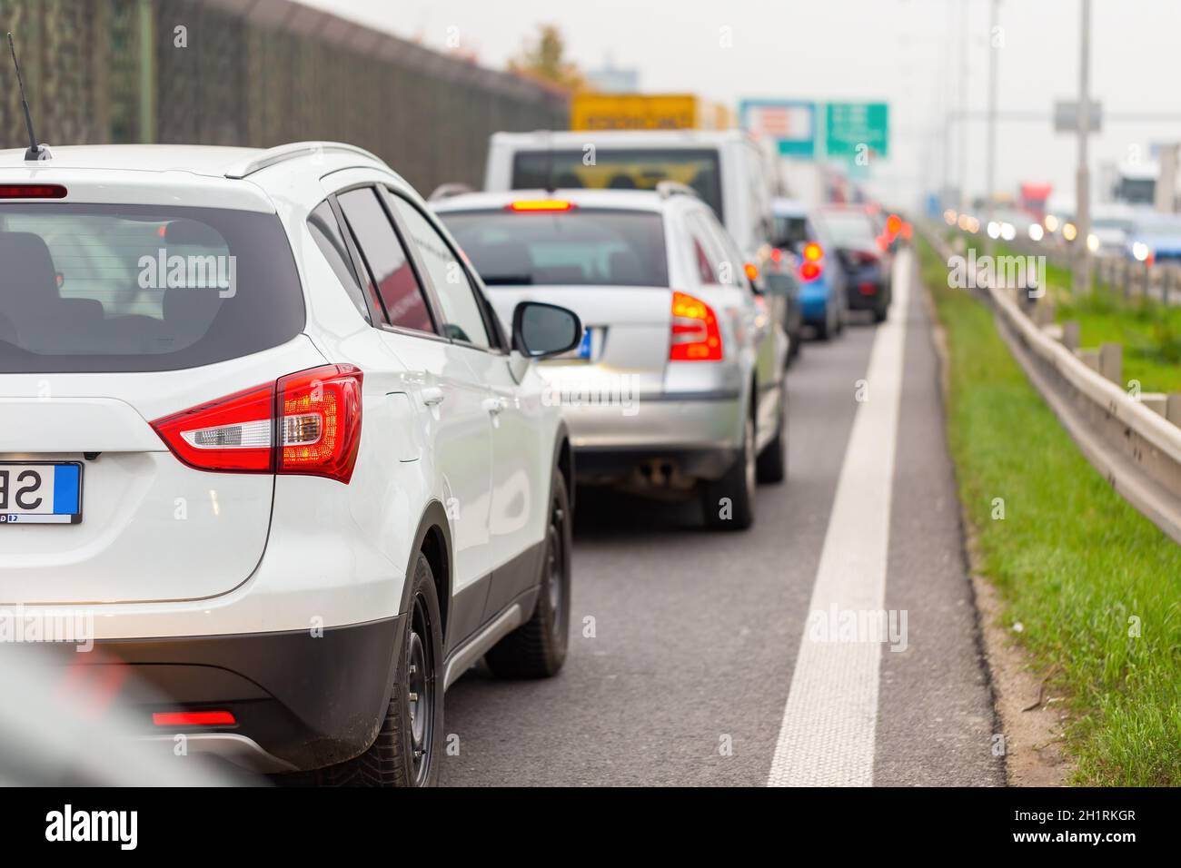 White modern car stuck in traffic jam on a highway. Concept of rush ...