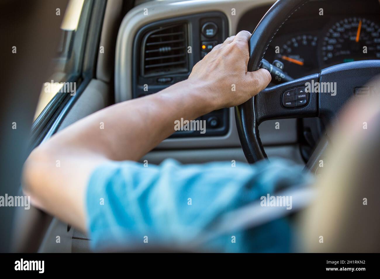 Driver's hands on the steering wheel Stock Photo - Alamy