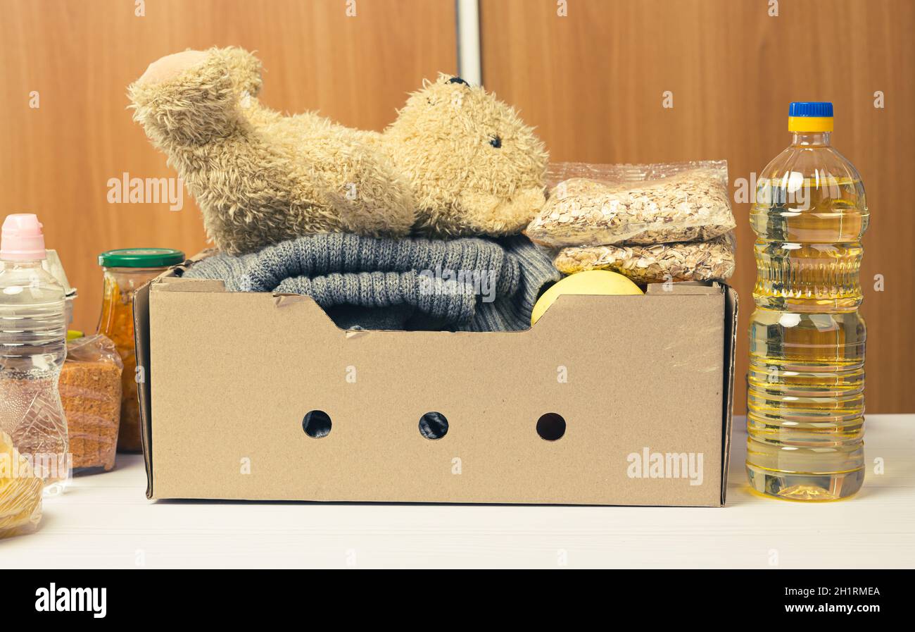 cardboard box with food and things to help those in need, help concept ...