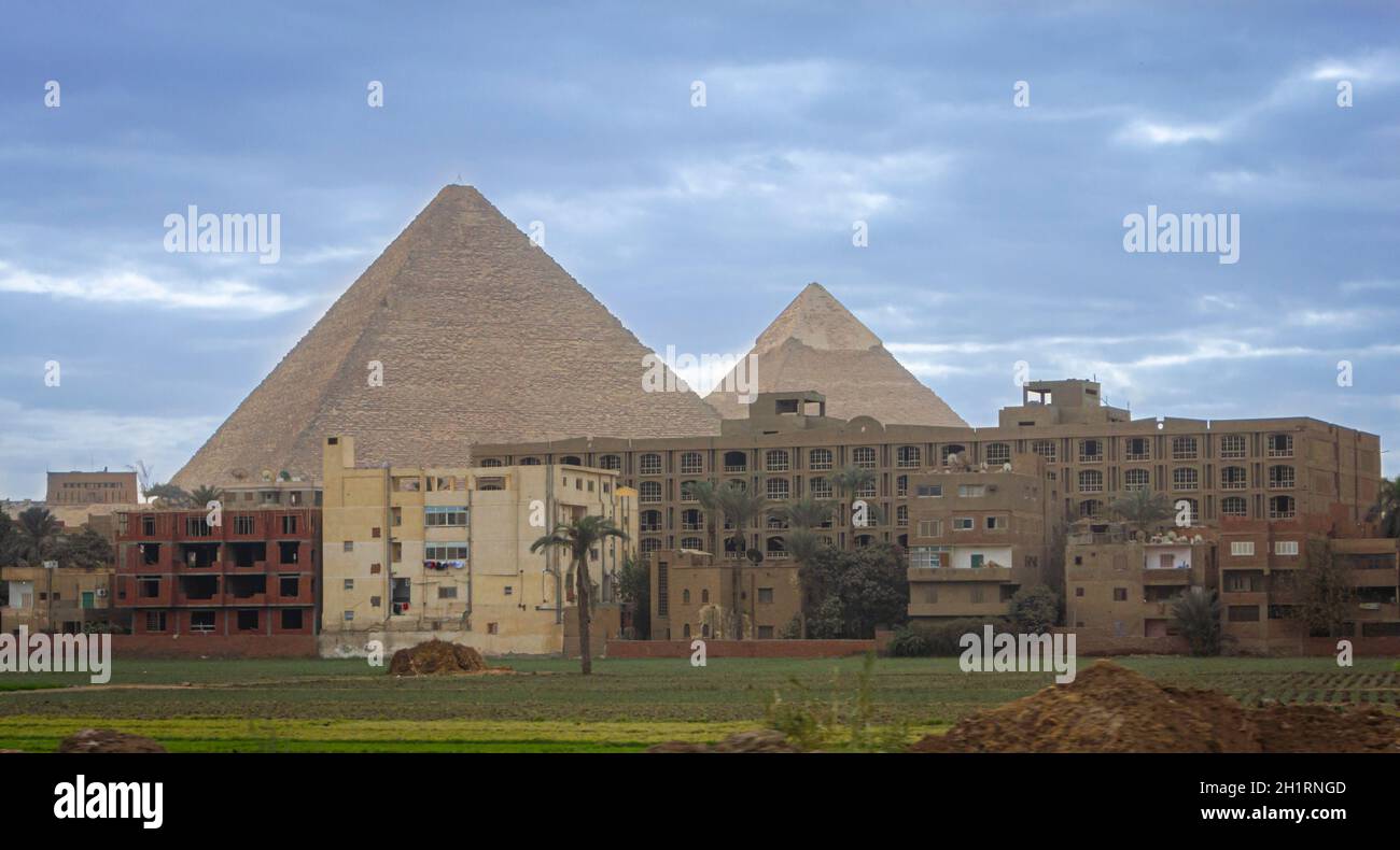 View of the Egyptian pyramids behind new buildings at Cairo, Egypt ...