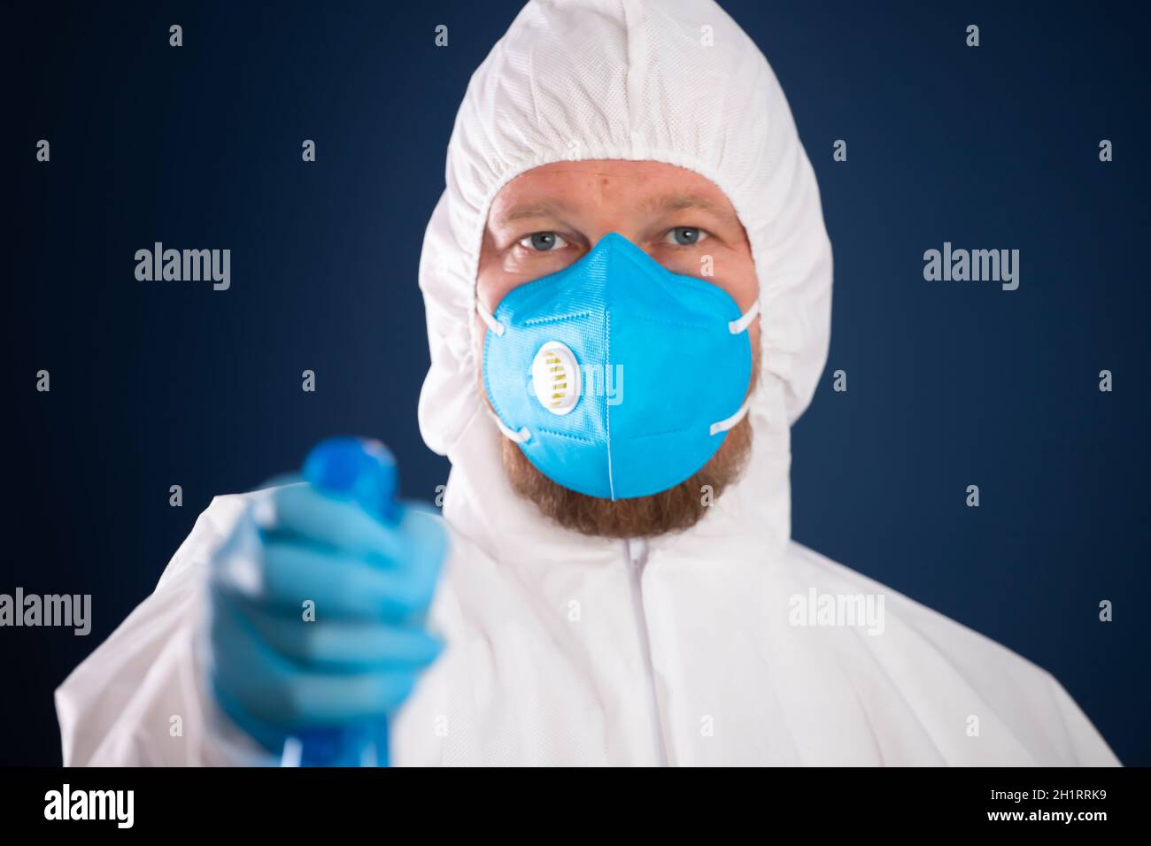 Conavirus pandemic. Man in full protected suit with disinfectant for ...