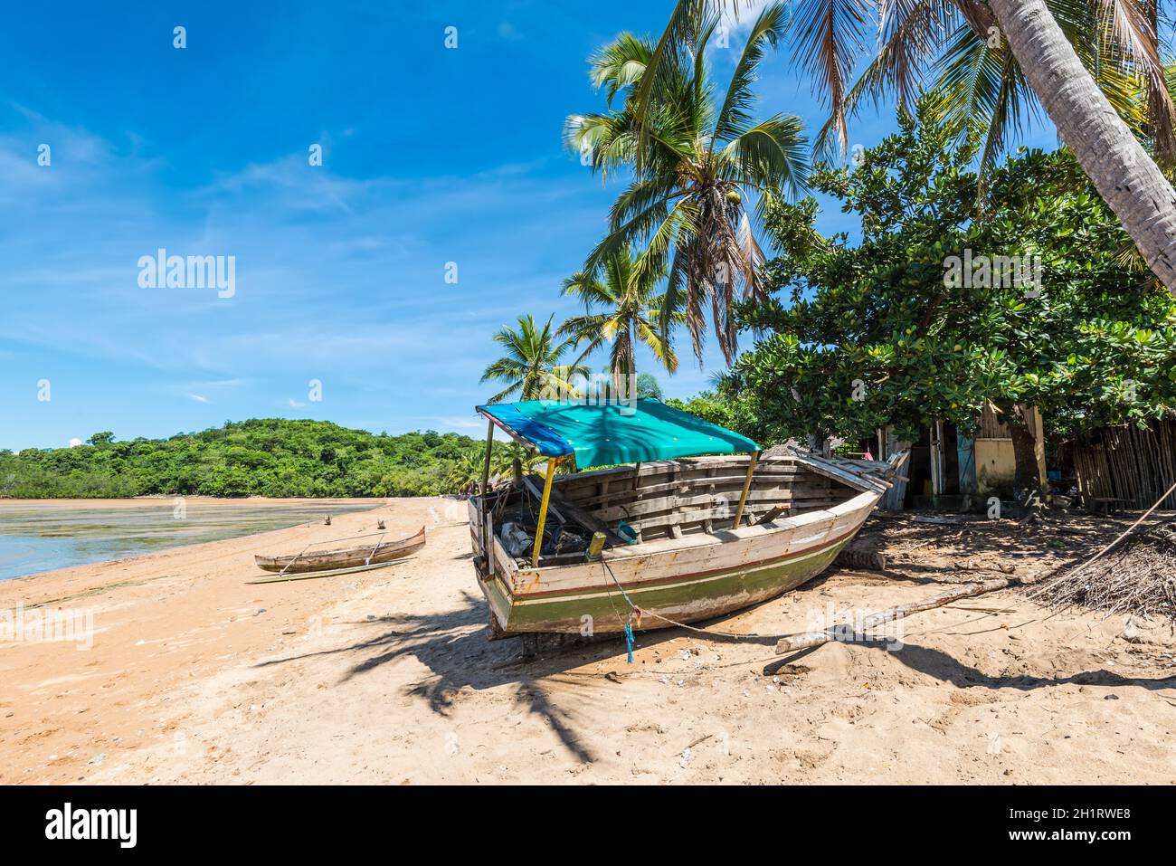 Wooden boat on the beach in a fishing village on Nosy Be island ...