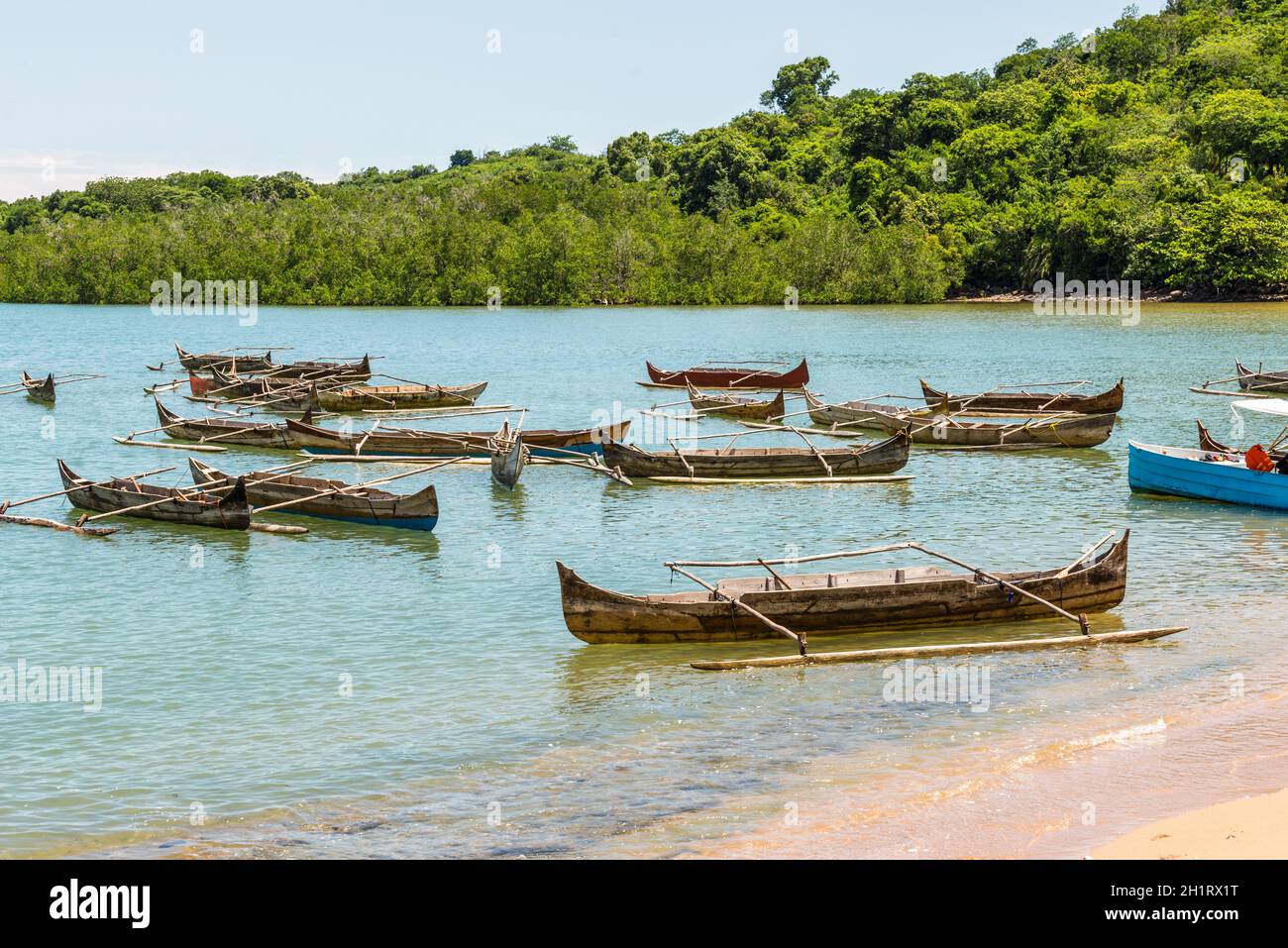 Traditional wooden dugout rowing outrigger canoes on Nosy Be island ...