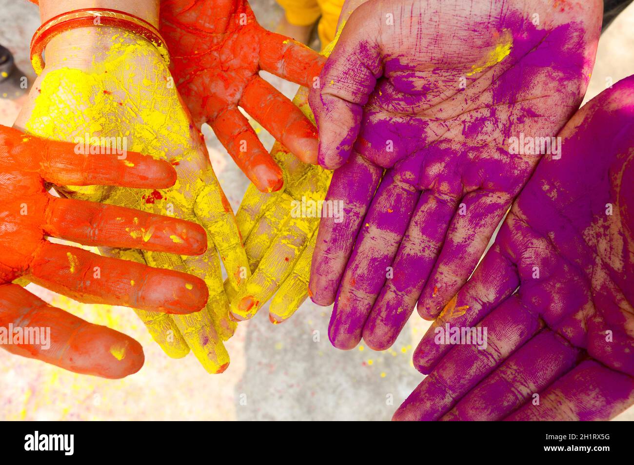 Young people with colorful powder in hands at holi festival in India ...