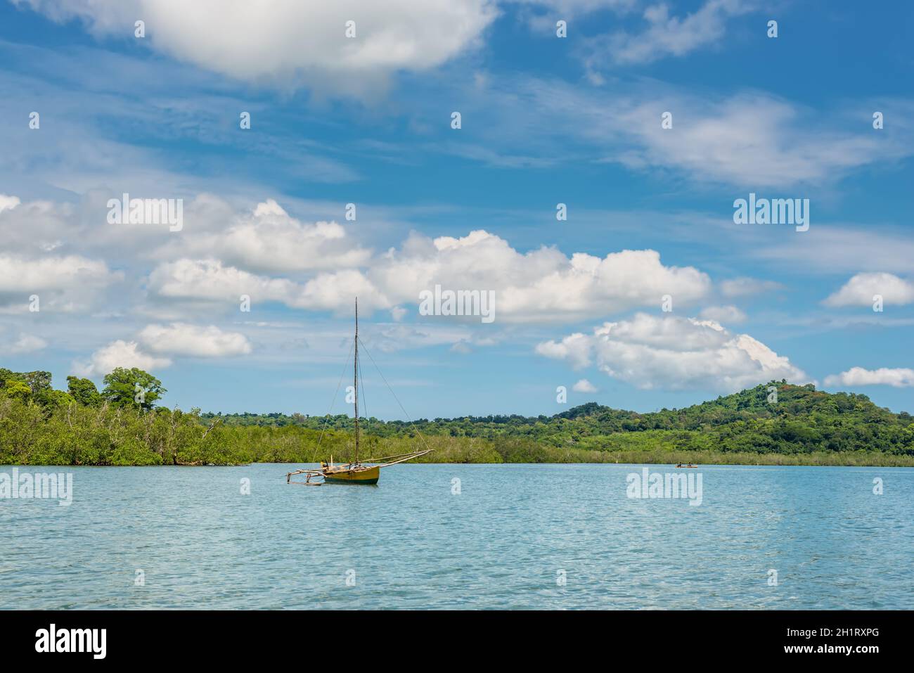 Seascape and traditional wood pirogue with outrigger near Nosy Be ...