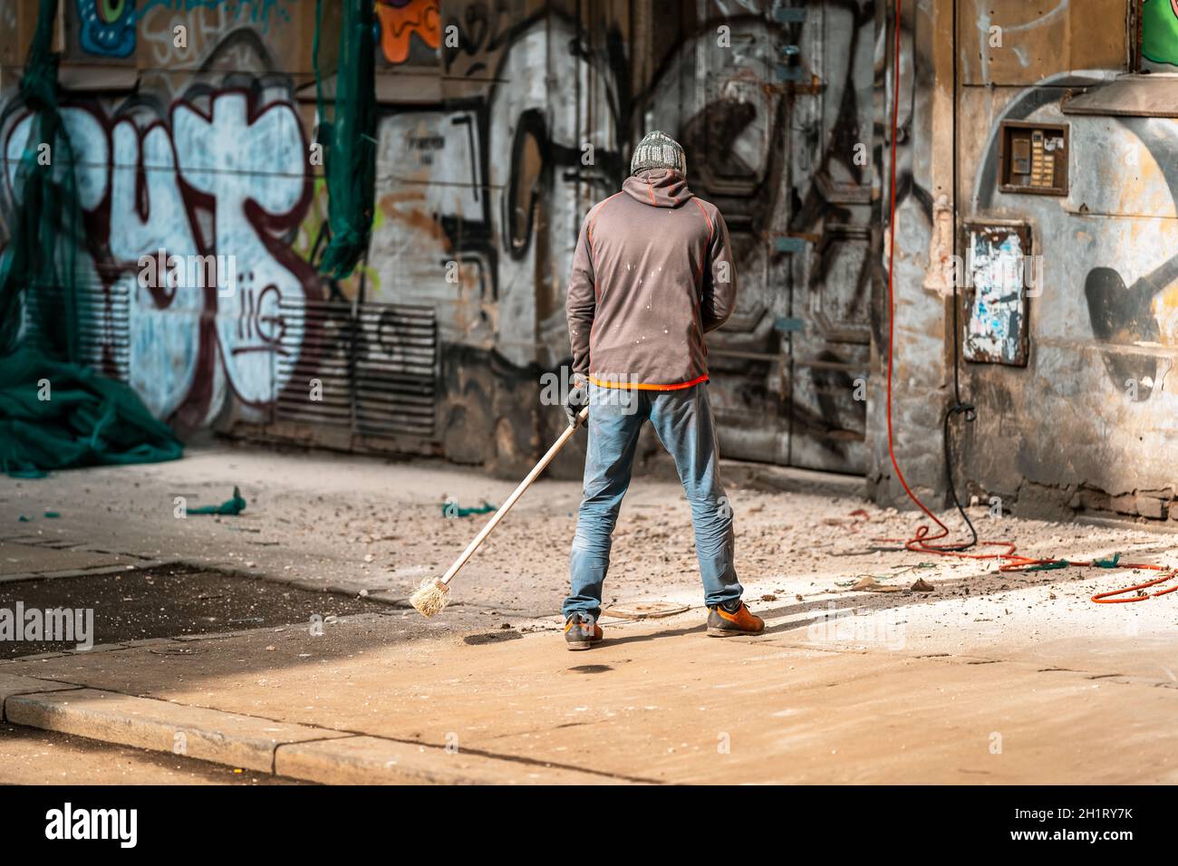 cleaning the city streets while repairing the facade of the house Stock ...