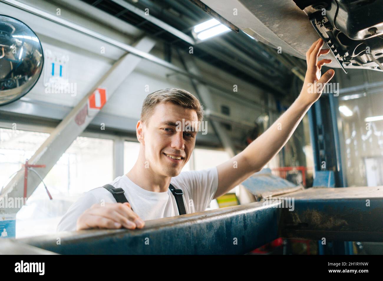 Close-up face of smiling handsome professional male car mechanic in ...