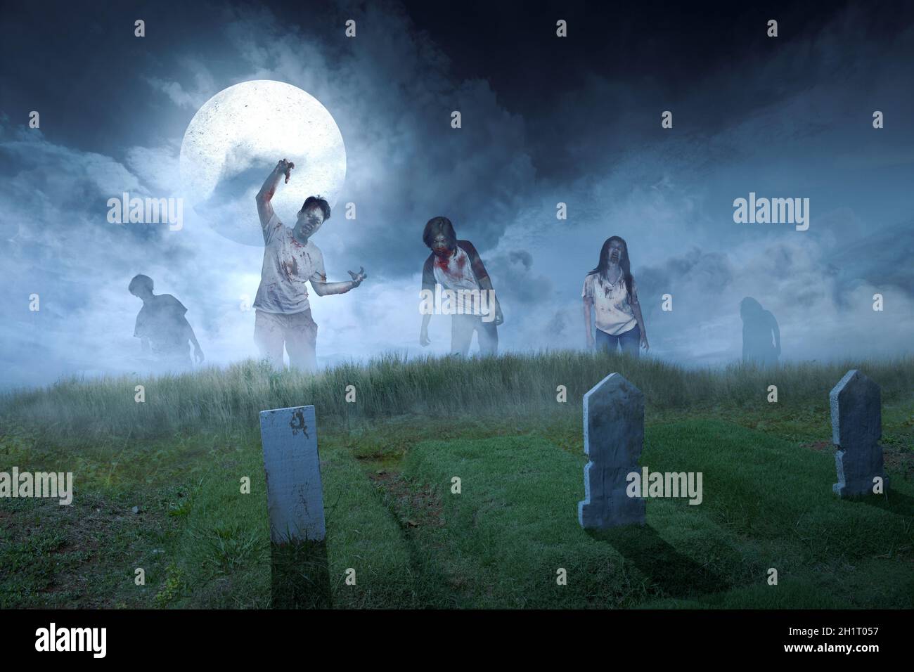 Scary zombies with blood and wound on his body walking in the cemetery ...