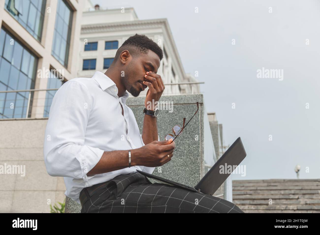 Feeling exhausted. Frustrated young black african man keeping eyes ...