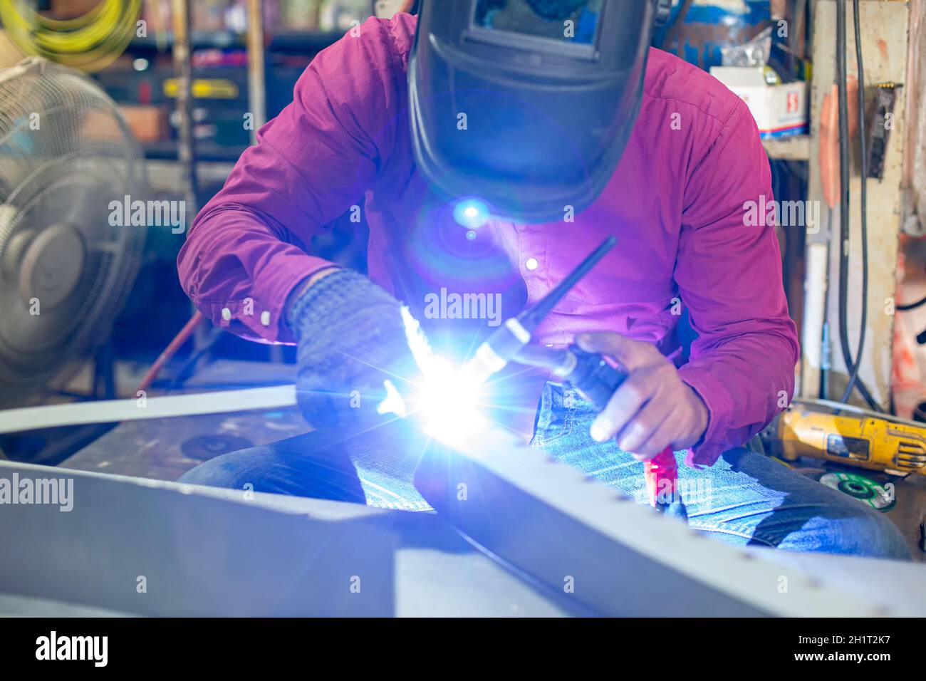 Welder used grinding stone on steel in factory with sparks, Welding ...