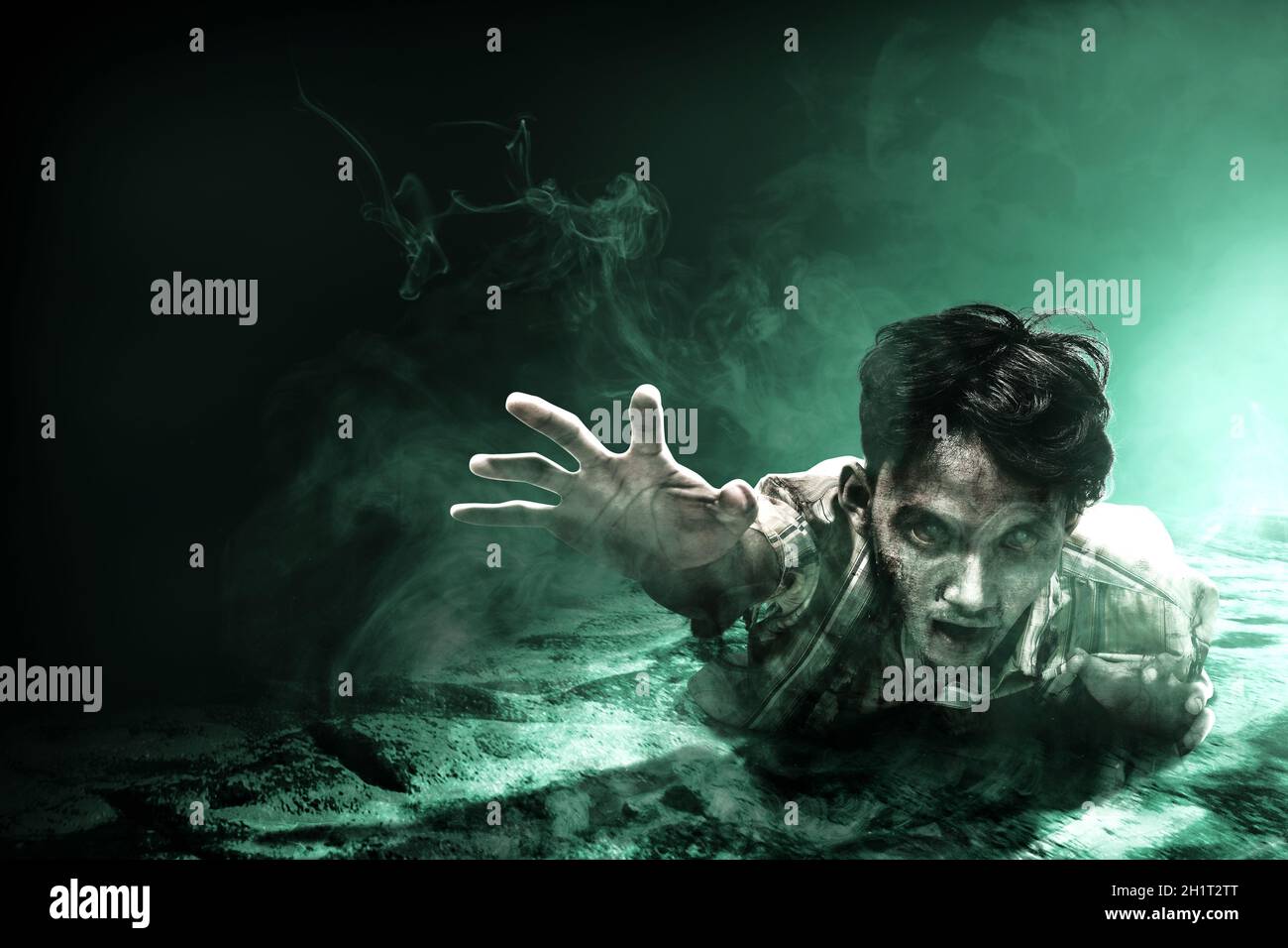 Scary zombie with blood and wound on his body crawling on dark ...