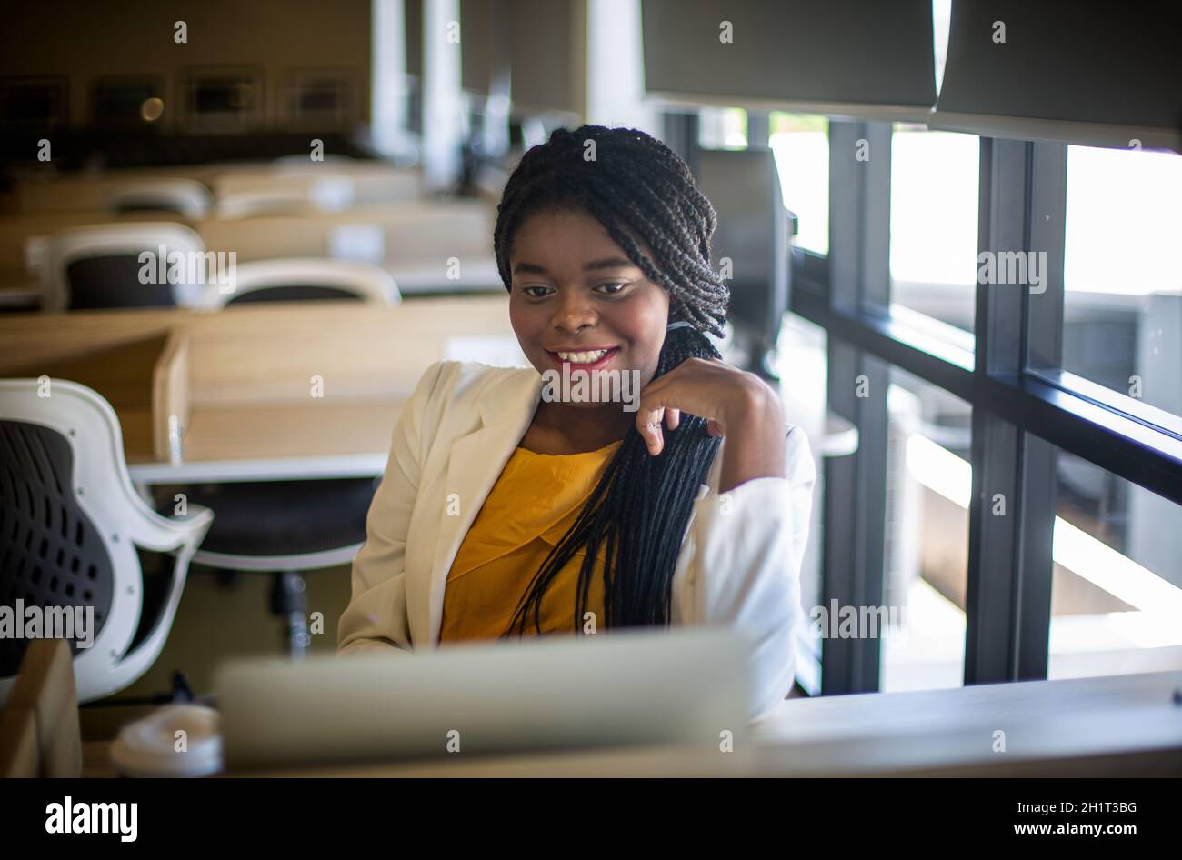 Young African American woman working using computer laptop concentrated ...