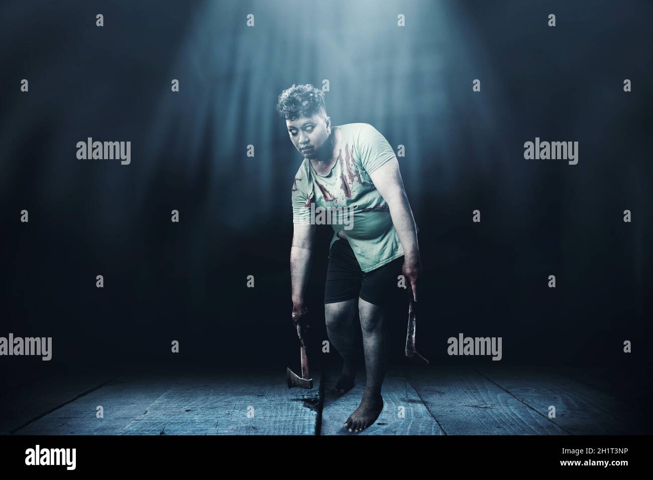 Scary zombie with blood and wound on his body holding ax and sickle ...