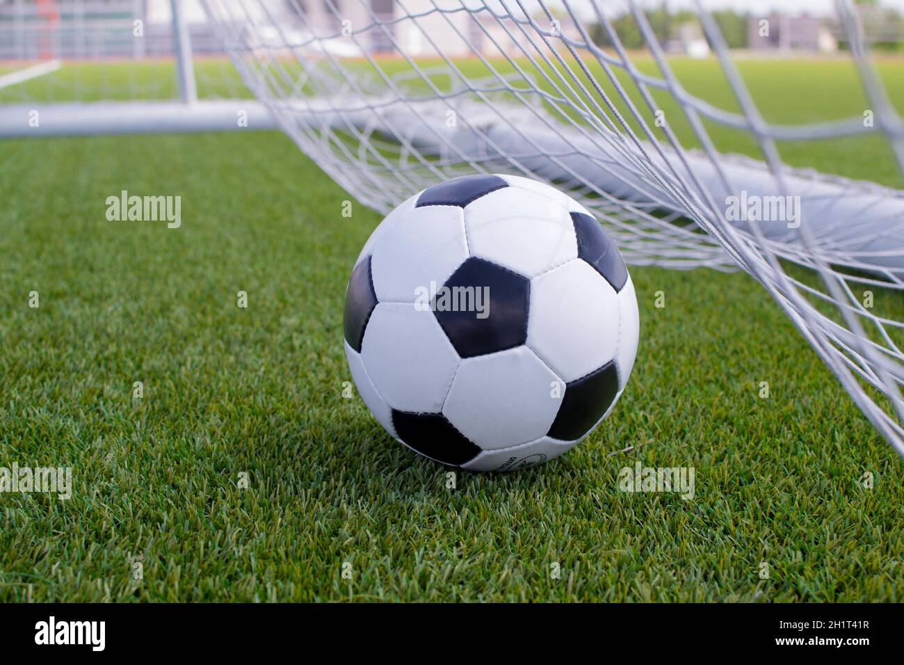 Soccer ball in the net on the lawn Stock Photo - Alamy