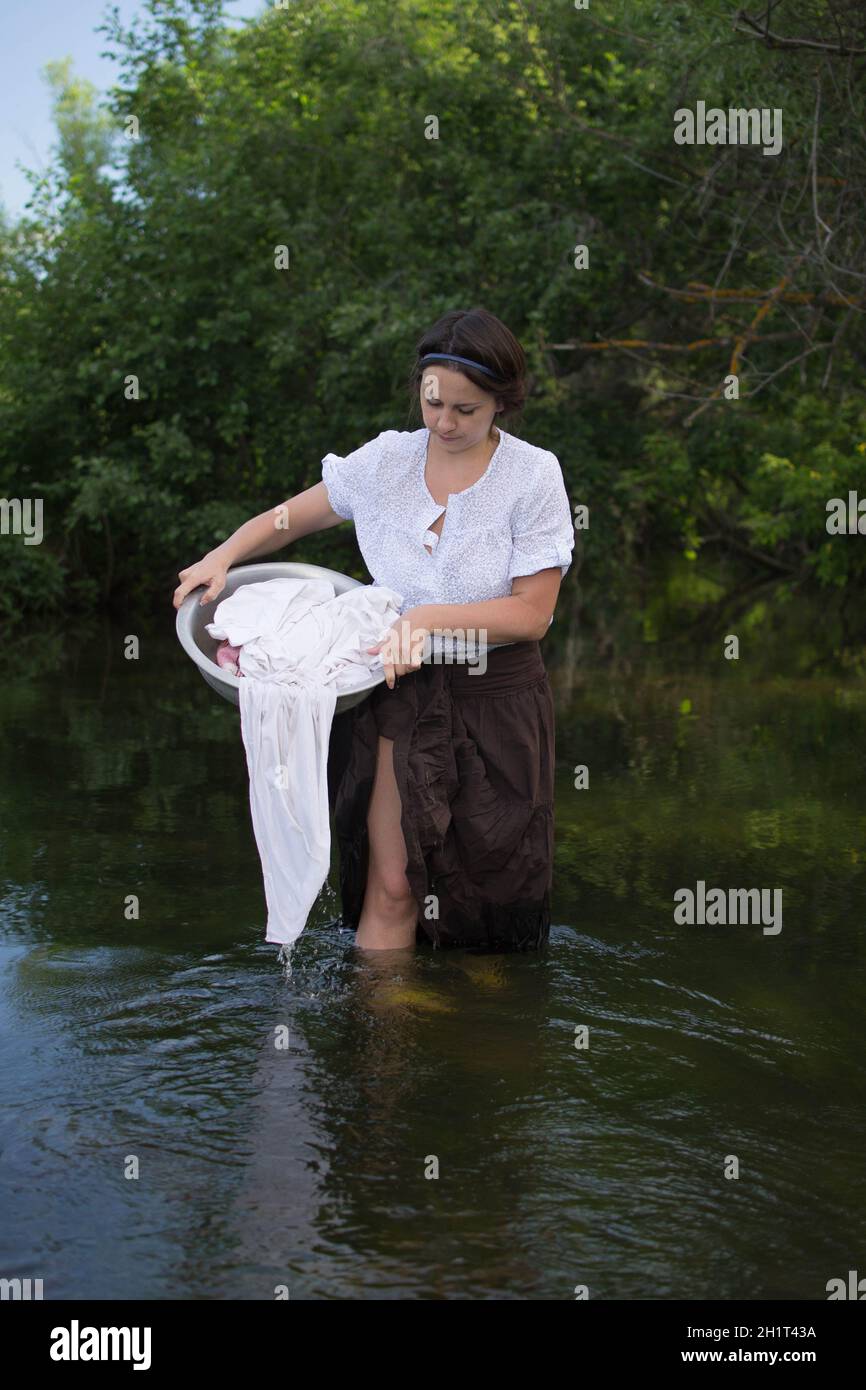 Woman washes laundry hi-res stock photography and images - Alamy