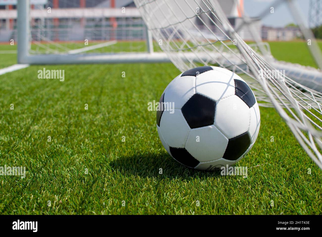 Soccer ball in the net on the lawn Stock Photo - Alamy