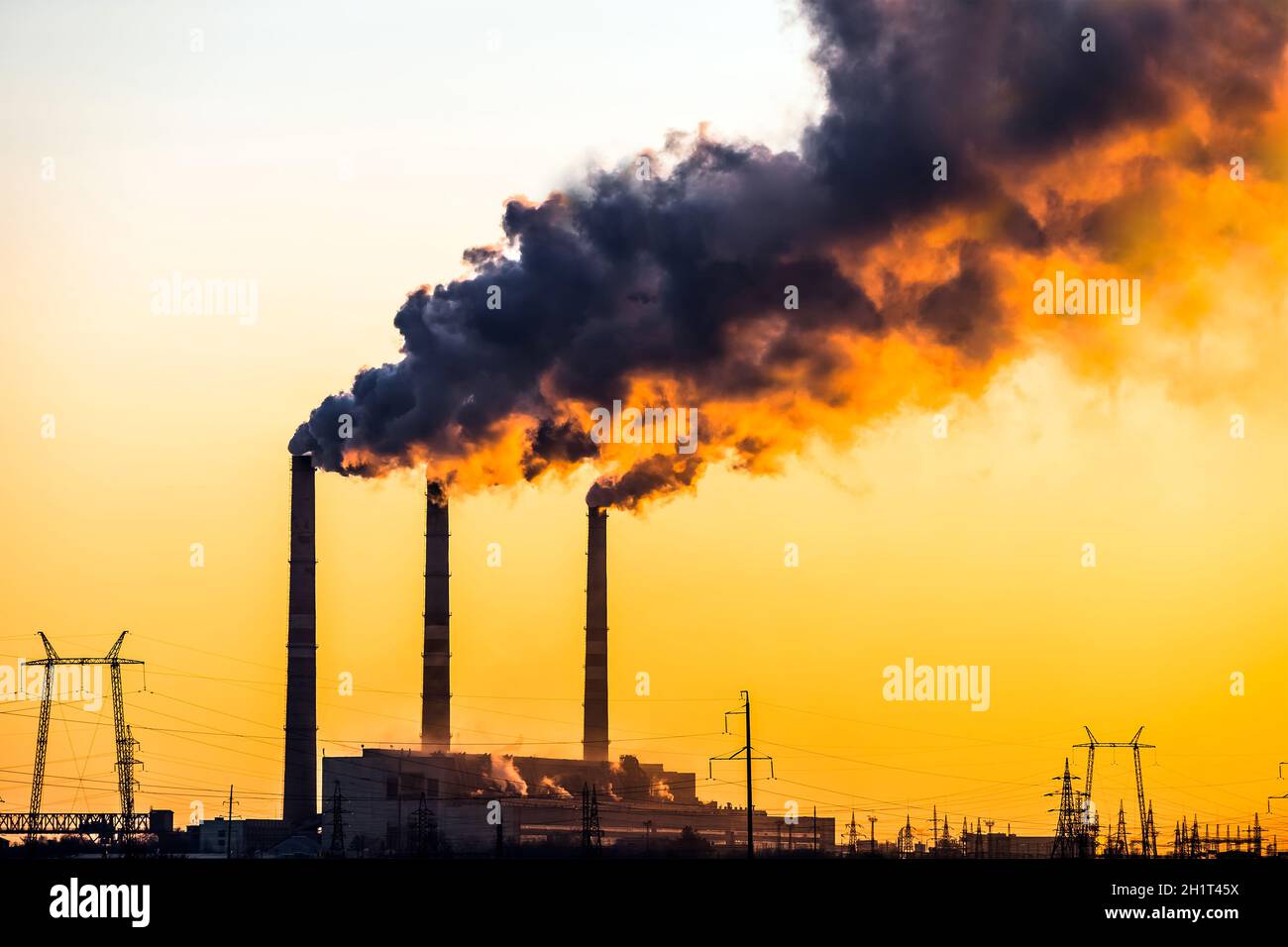 Sunset over the industrial city.Factory chimneys smoke.Environmental ...