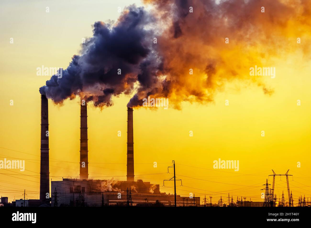 Sunset over the industrial city.Factory chimneys smoke.Environmental ...