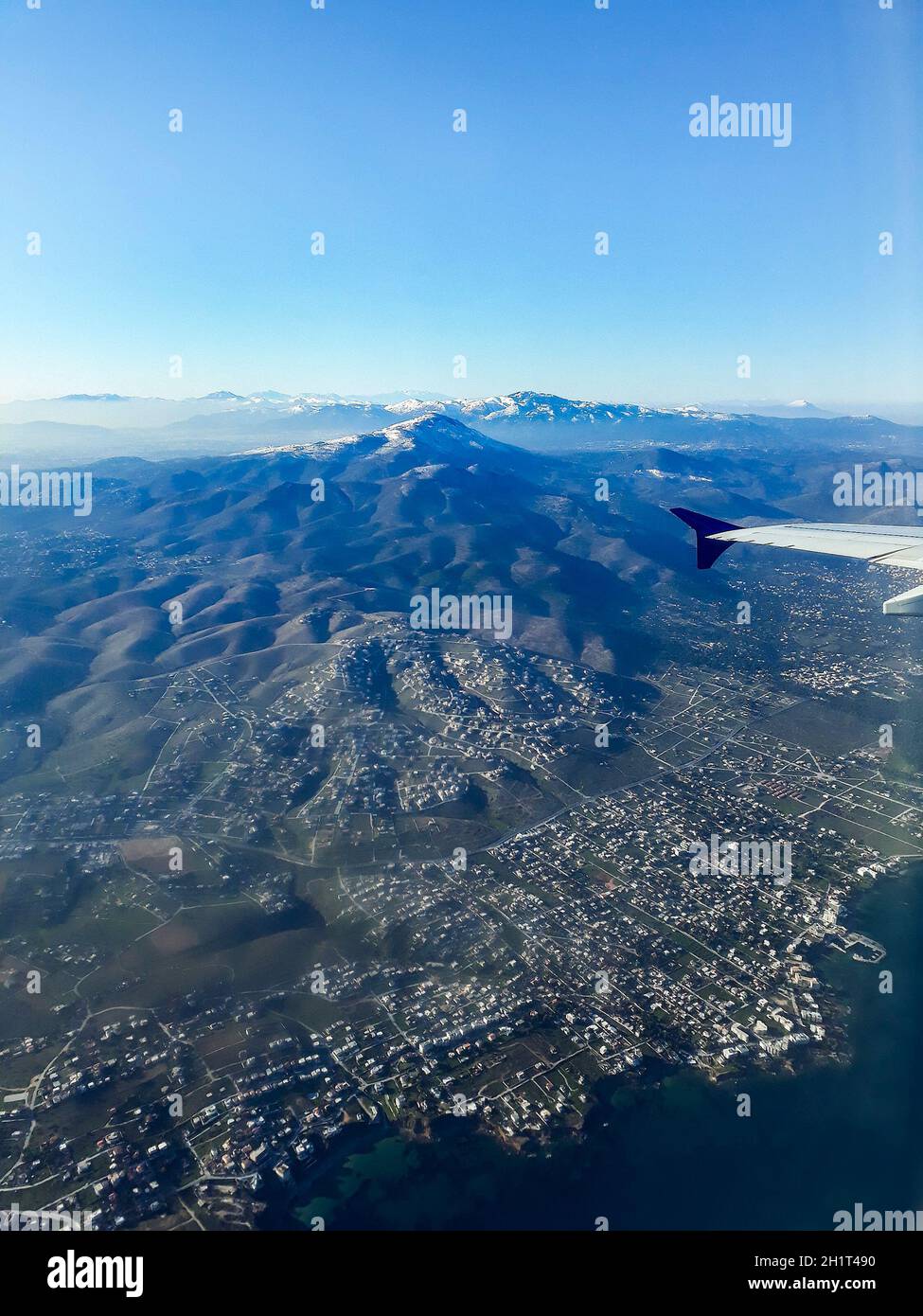 Window plane point aerial landscape of greece coast Stock Photo - Alamy