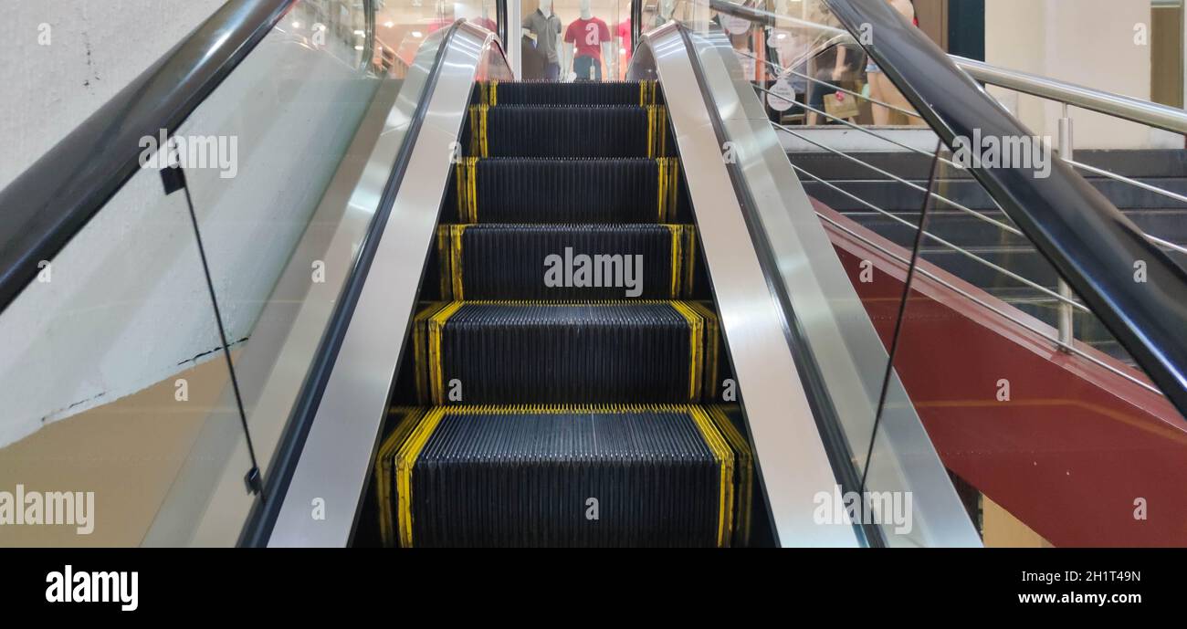 Escalator. Internal environment. Shopping center and clothing display ...