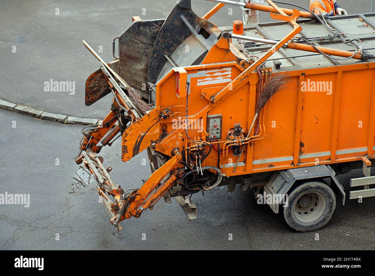 Garbage truck in urban city pavement shot from behind Stock Photo - Alamy
