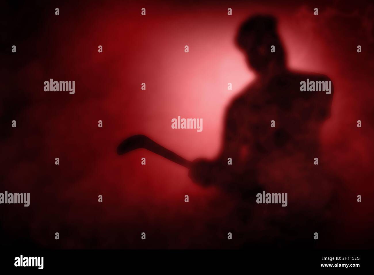 Silhouette of a scary zombie holding sickle with dramatic background ...