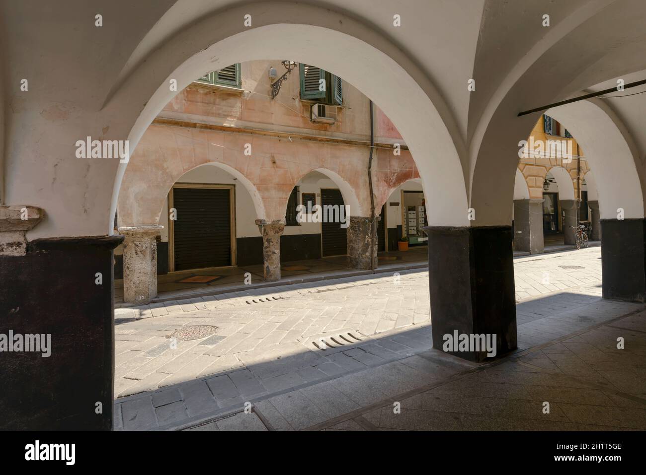 arches and stone pillars facing at old medieval covered walkway, shot ...
