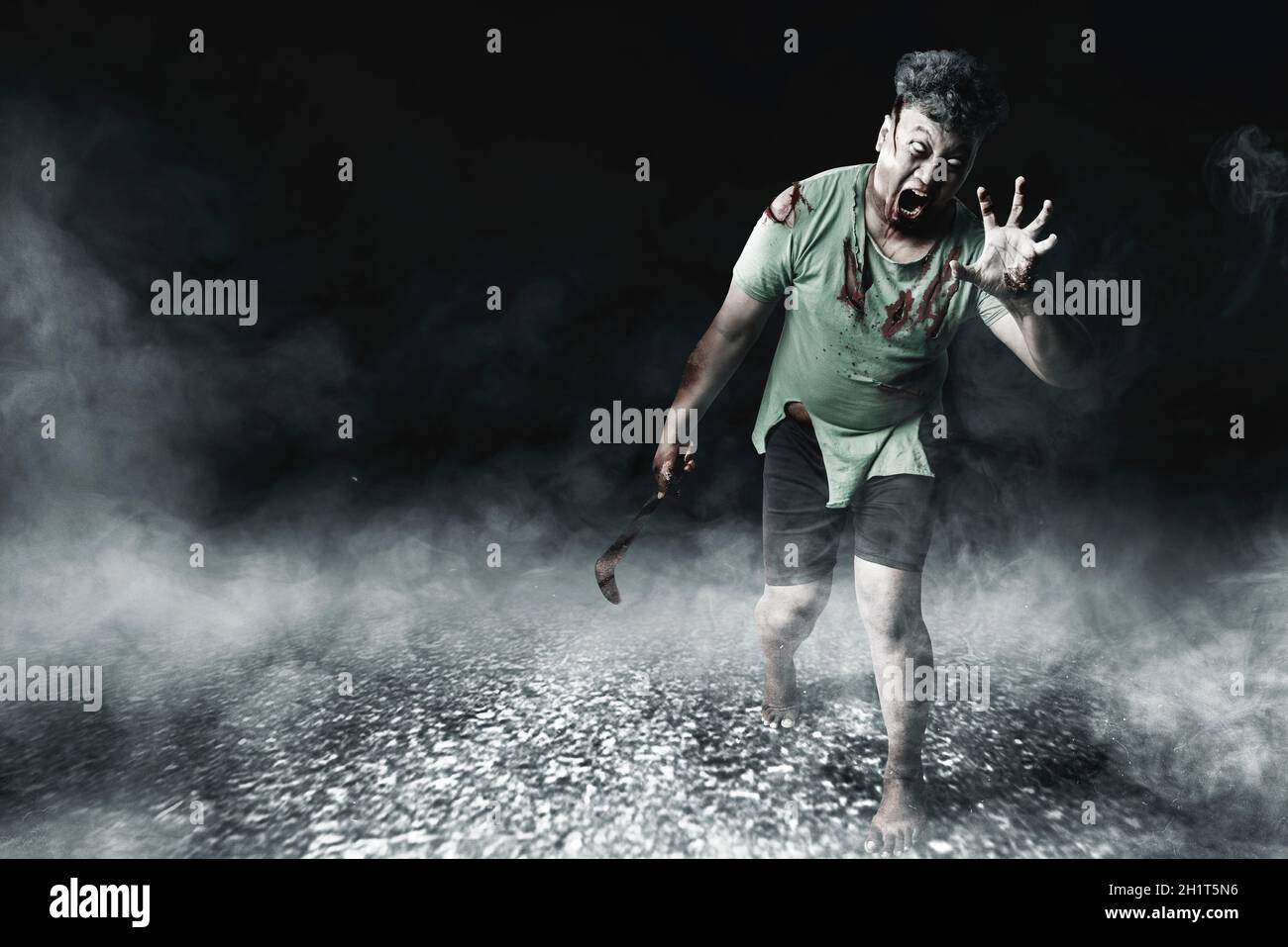 Scary zombie with blood and wound on his body holding sickle walking ...