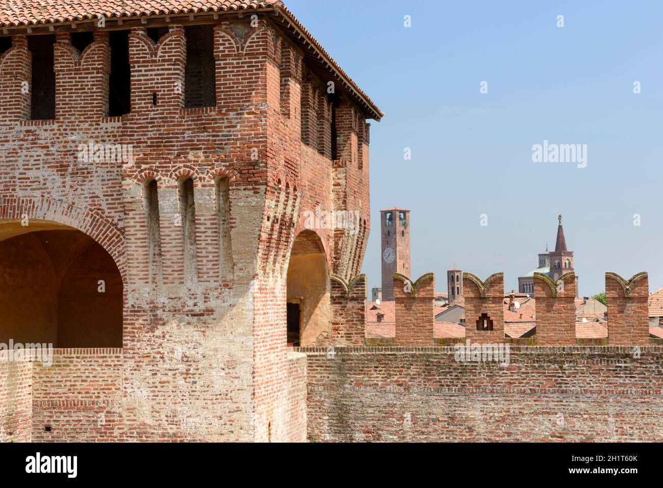 detail of merlons and tower of the ancient Sforzesco Castle with city ...