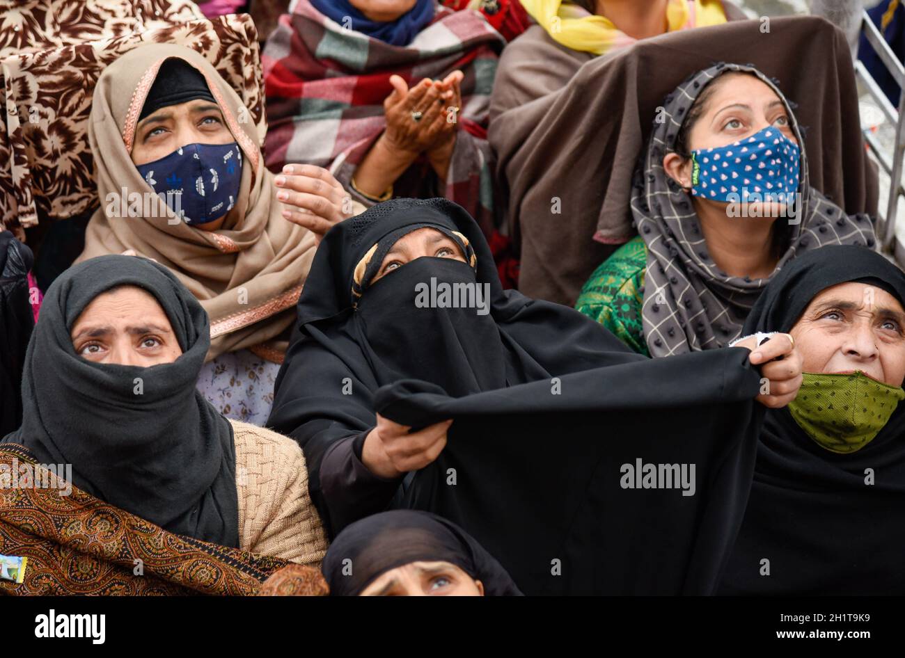 Kashmiri Muslim devotees raise their hands while beseeching for ...